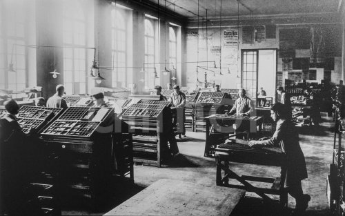 Early 20th century typesetters arranging types called typesetting for ...